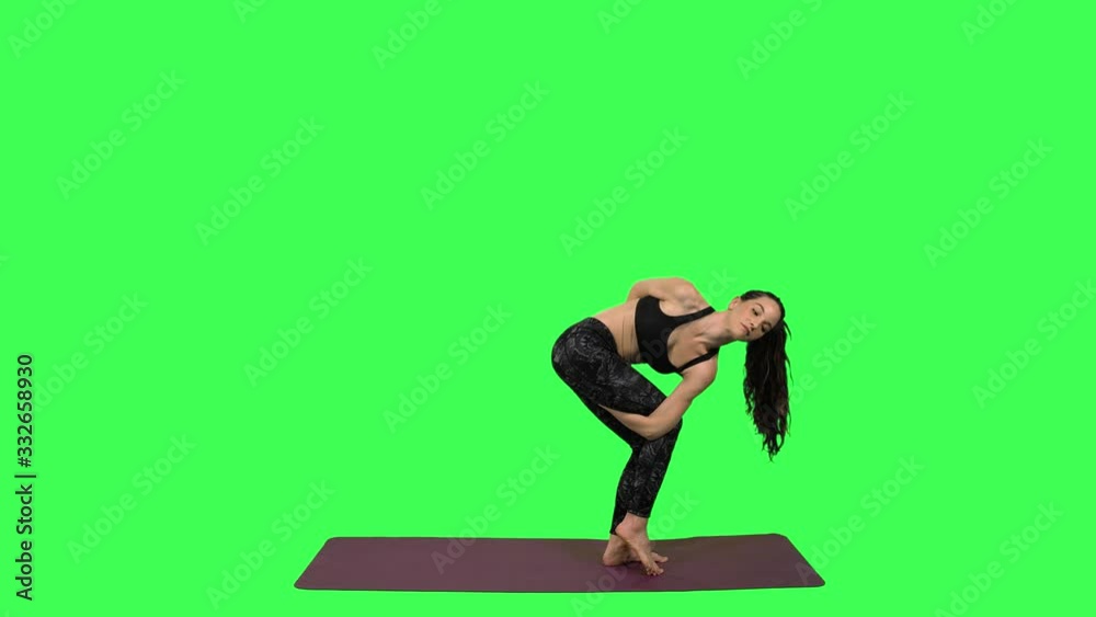 Professional Yoga Instructor practices various complex standing ...