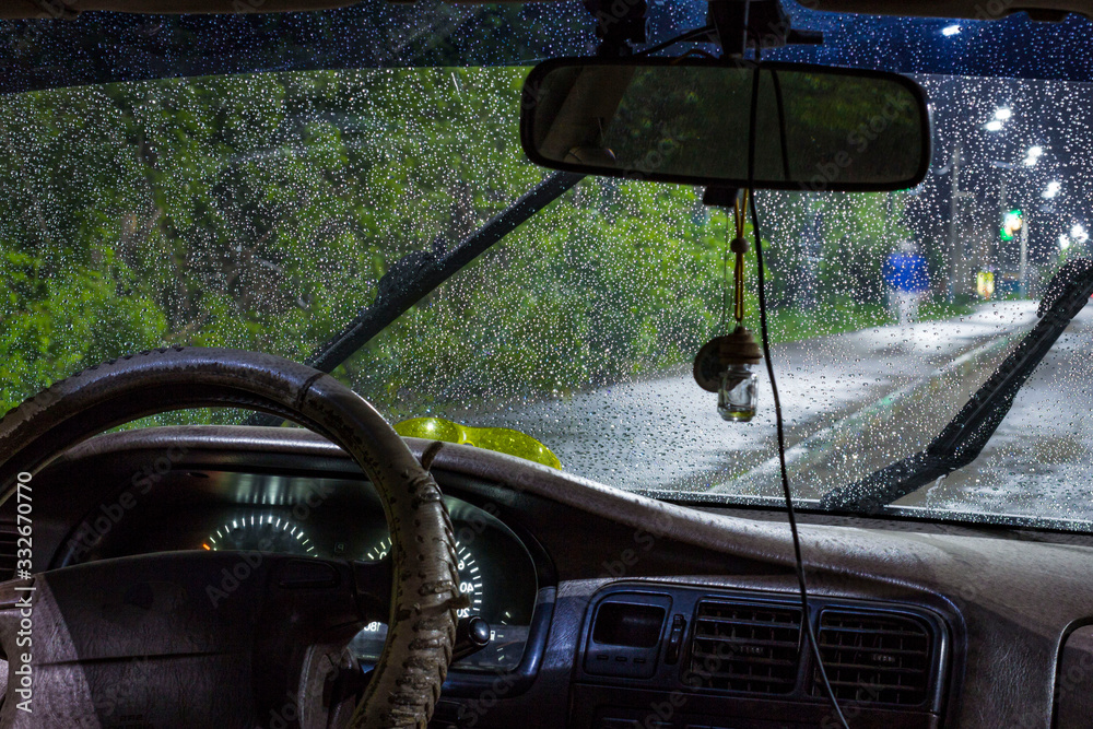 beautiful drops of water on the windshield of the car with the glass ...