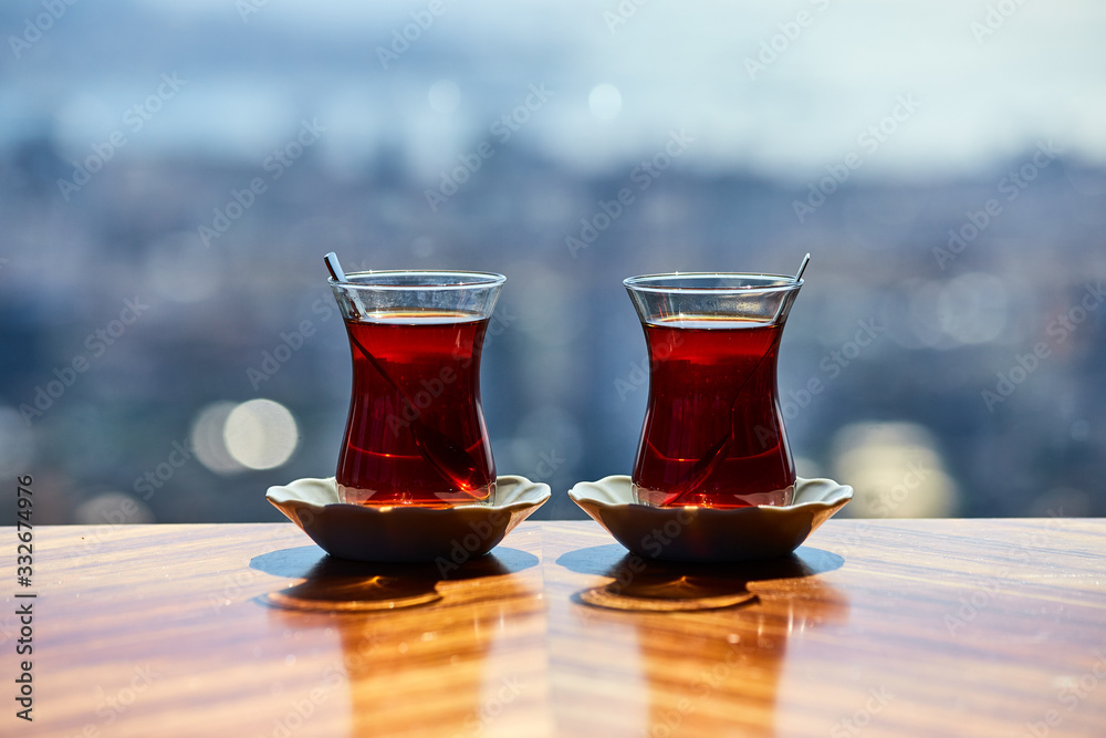 Two cups (armudas) of traditional Turkish tea are served on a table ...