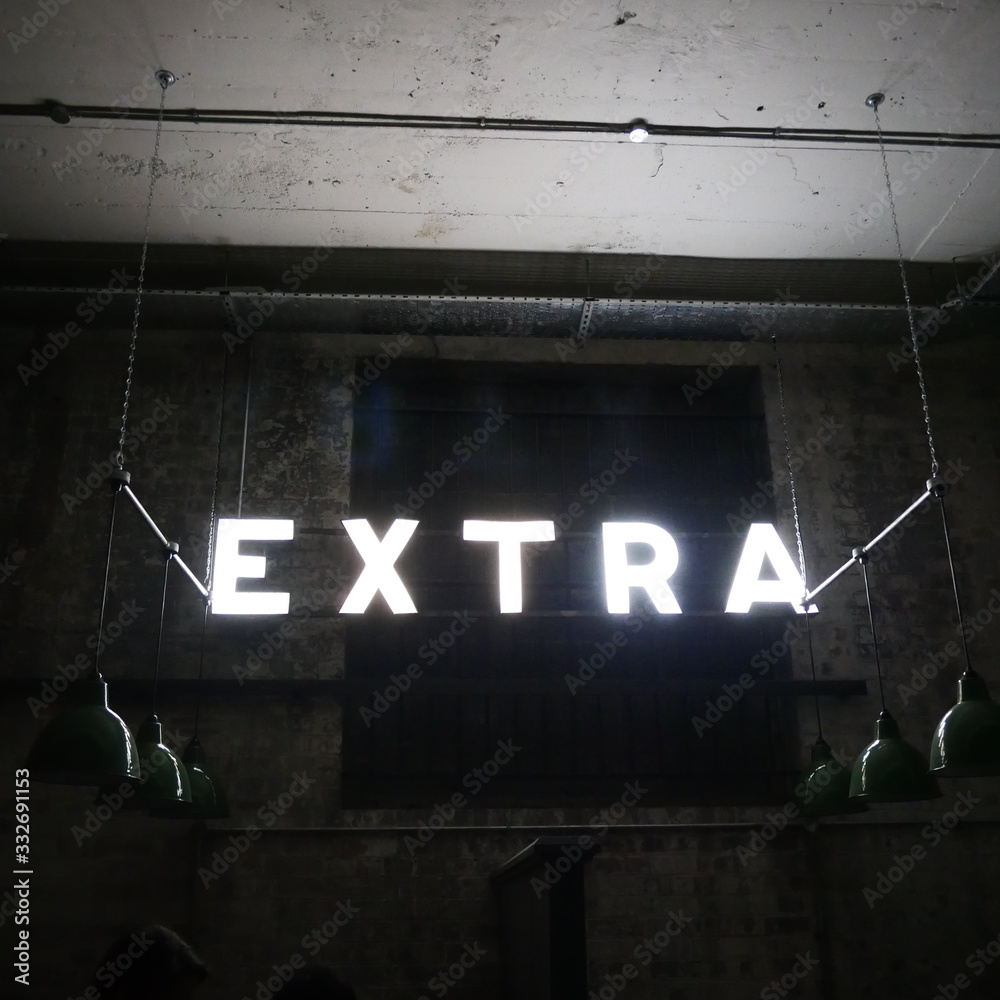 extra sign on warehouse wall Stock Photo | Adobe Stock