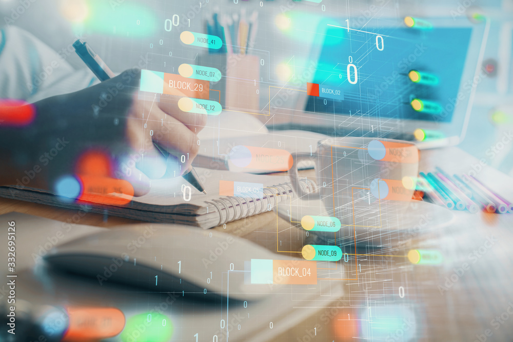 Double exposure of hands making notes with digital coding icons ...