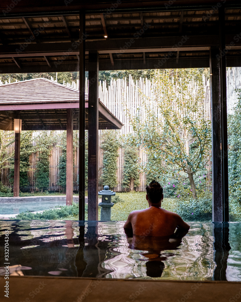 Onsen wooden bath tub,man enjoys bath at hot springs in Chiang Mai ...