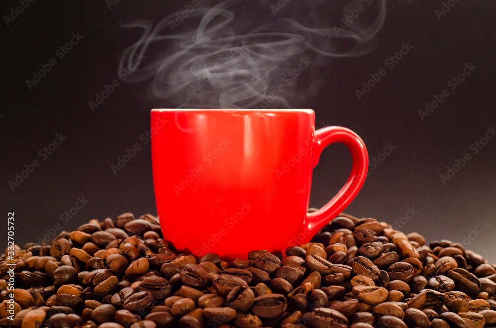 Red cup of hot coffee with steaming on roasted coffee beans and dark ...