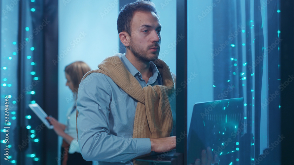 Server tech support with headset performing data operations in server ...