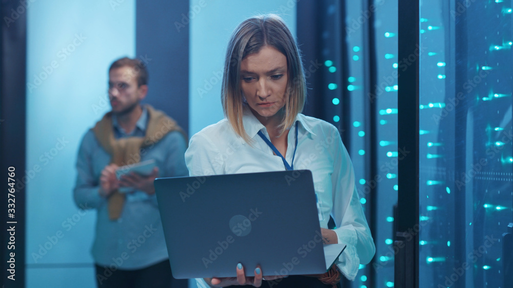 Woman IT administrator checking rack server hardware doing transparent ...