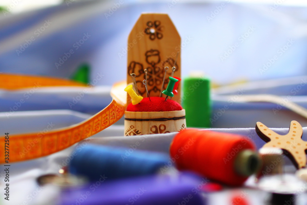 sewing still life with spools of colored thread, with beautiful buttons ...