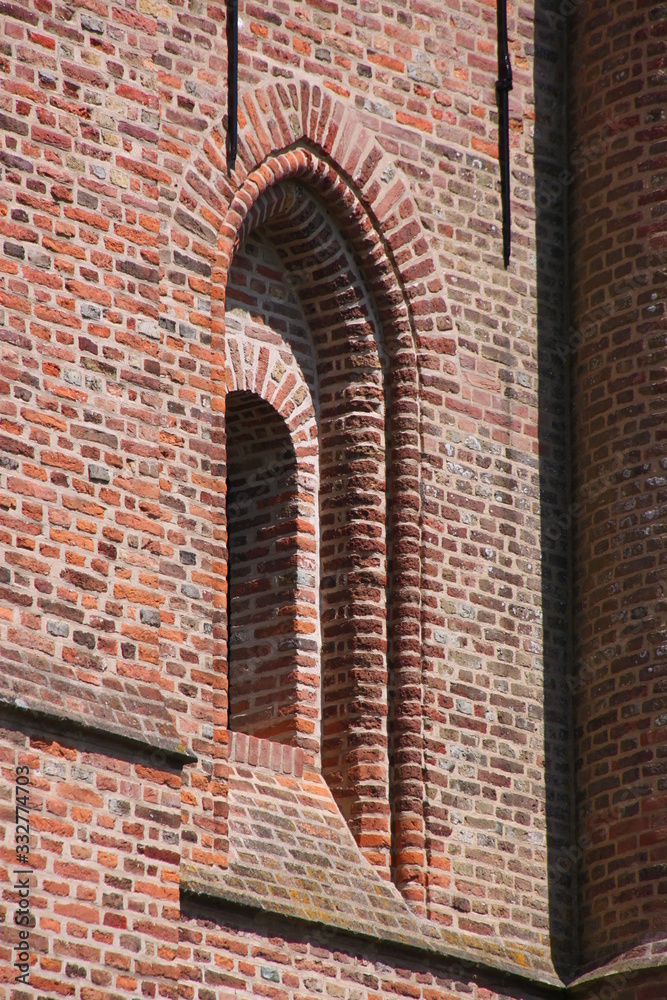 Texture of a simple gothic window arch on the brick facade of the ...