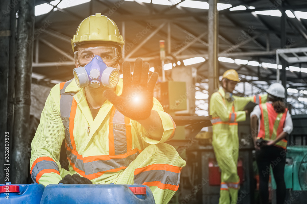 Man engineer wearing safety uniform with gloves and gas mask show a ...