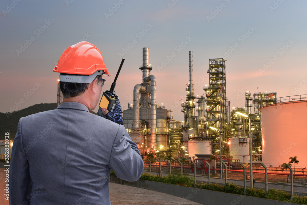 Worker in Oil Refinery discussion and pointing for inspection by hand ...