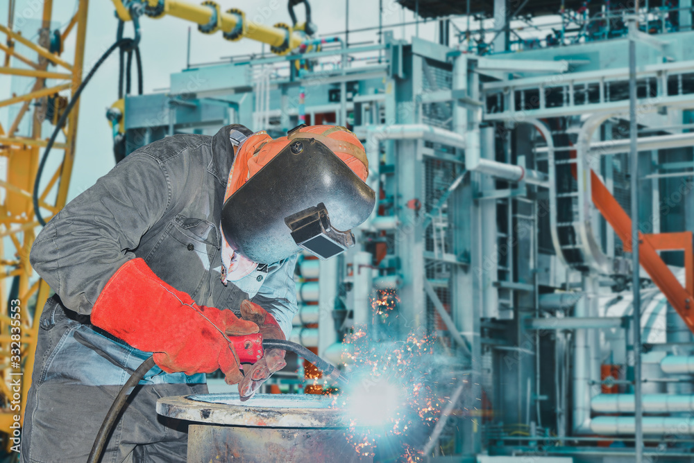 Welder is welding Industrial worker at factory welding close up ...