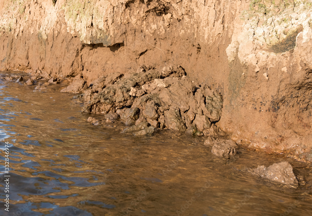 Soft soil river bank erosion Stock Photo | Adobe Stock