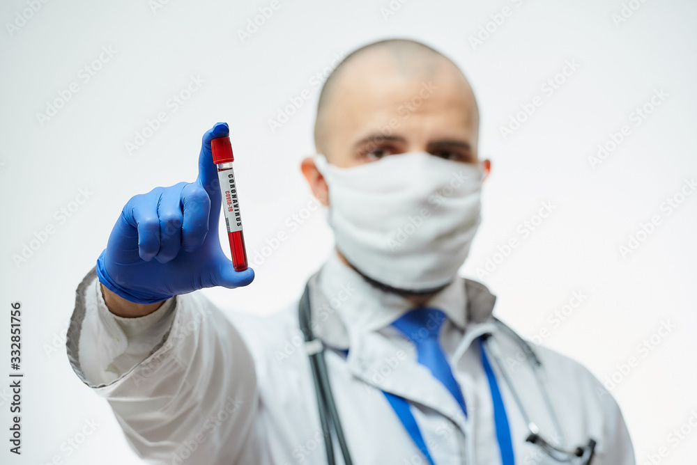 A doctor in a medical protective face mask demonstrating a positive ...