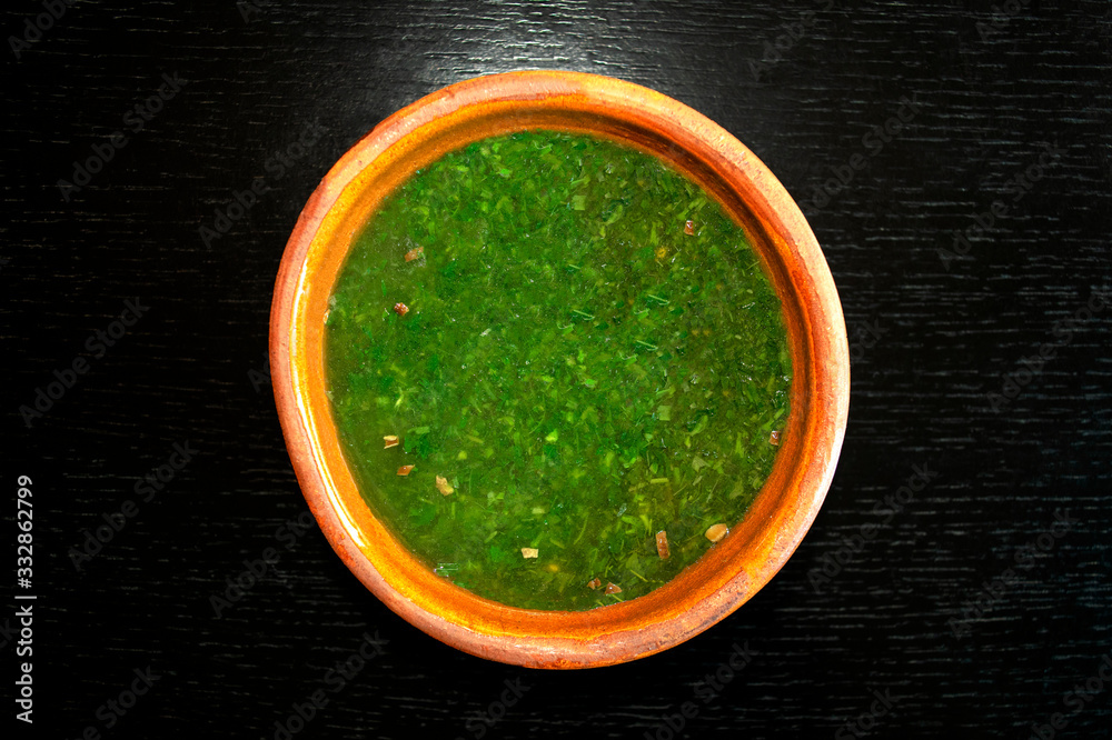 Famous traditional Arabic cuisine. Molokhia soup in brown bowl on dark ...