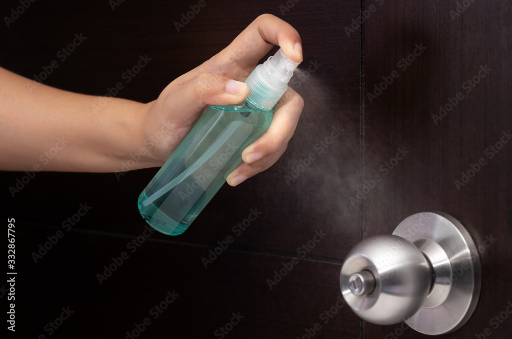 disinfect, sanitize, hygiene care. inject alcohol spray on door knob ...