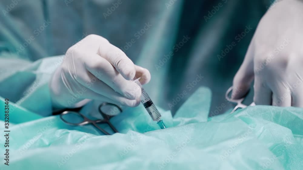 The surgeon doctor gives an injection during the operation. Local ...
