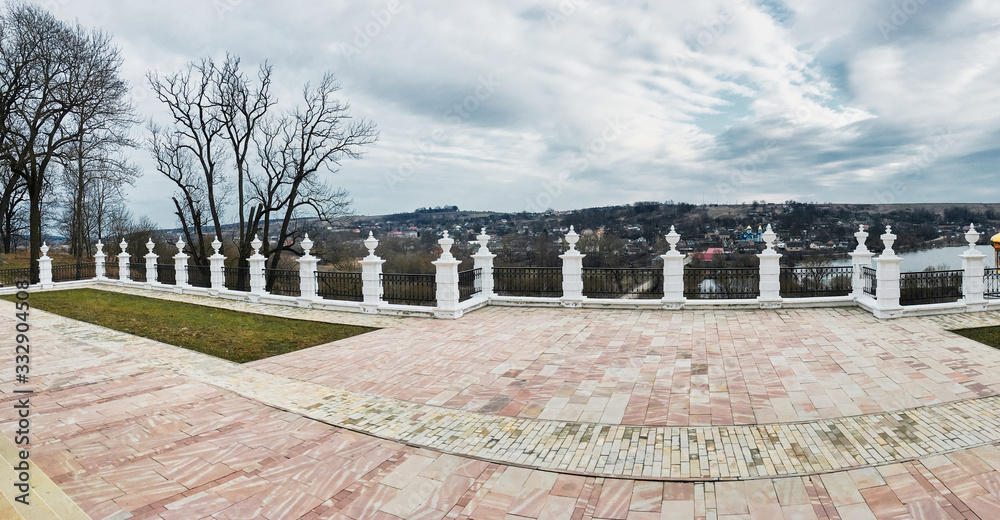White concrete fence with curved pillars in old historical park of ...
