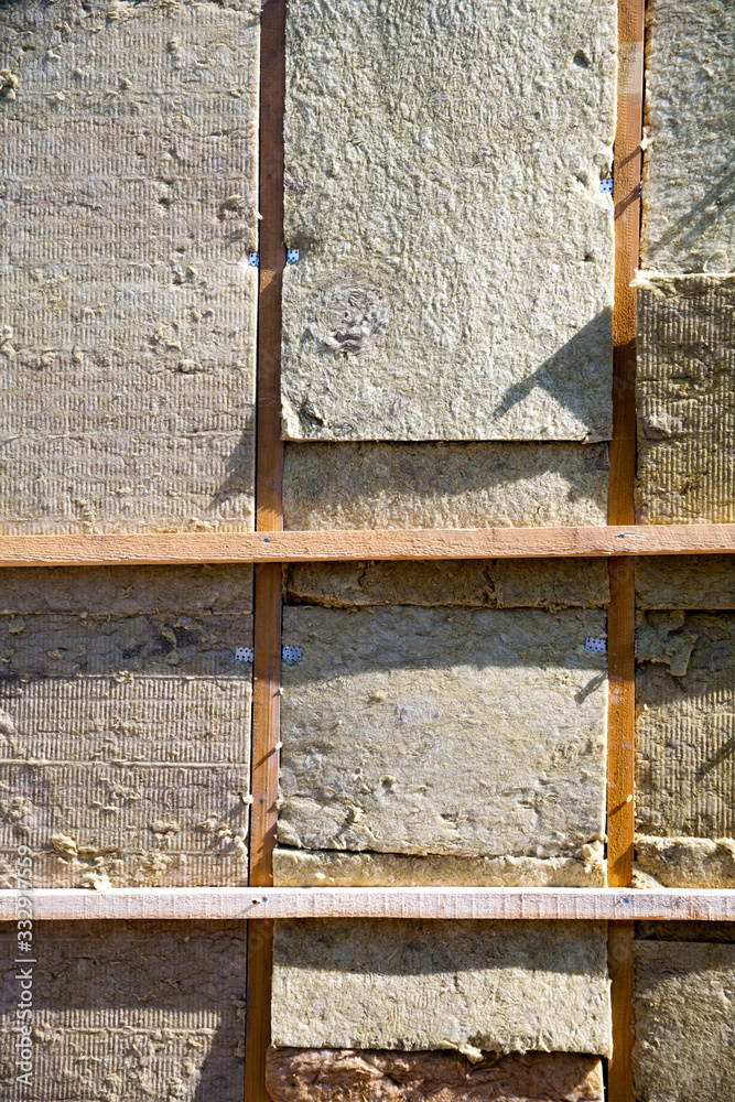 warming the walls of a stone house with a stone wool heater. Ecological ...