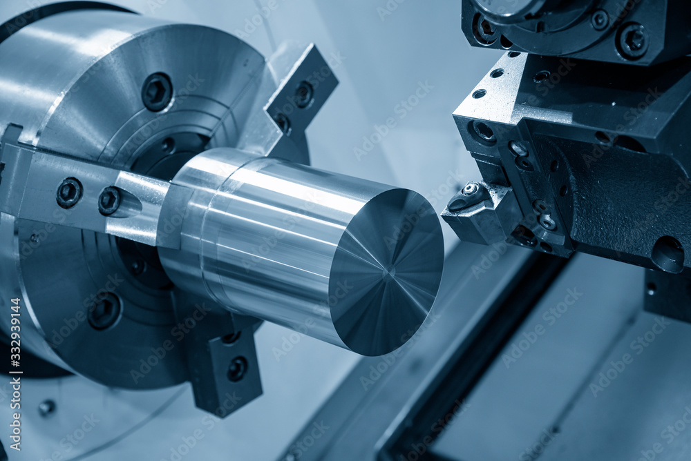 The CNC lathe machine rough cutting the metal shaft parts with lighting ...