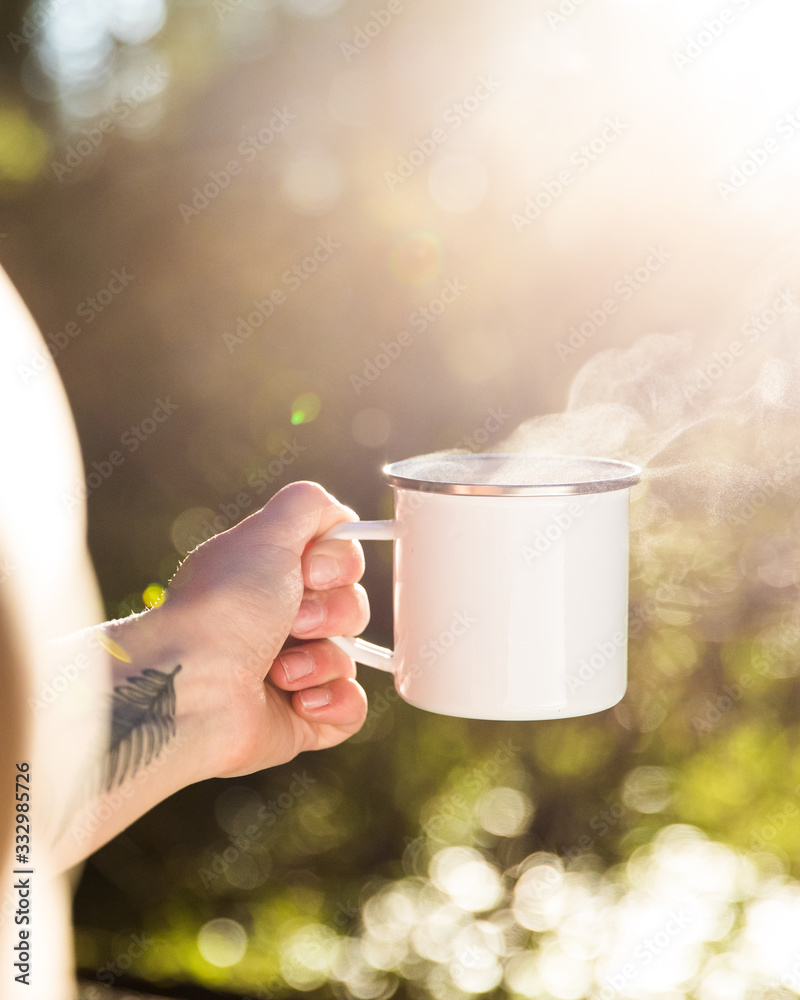 Blank white enamel coffee mug held by a hand in the forest Stock Photo ...