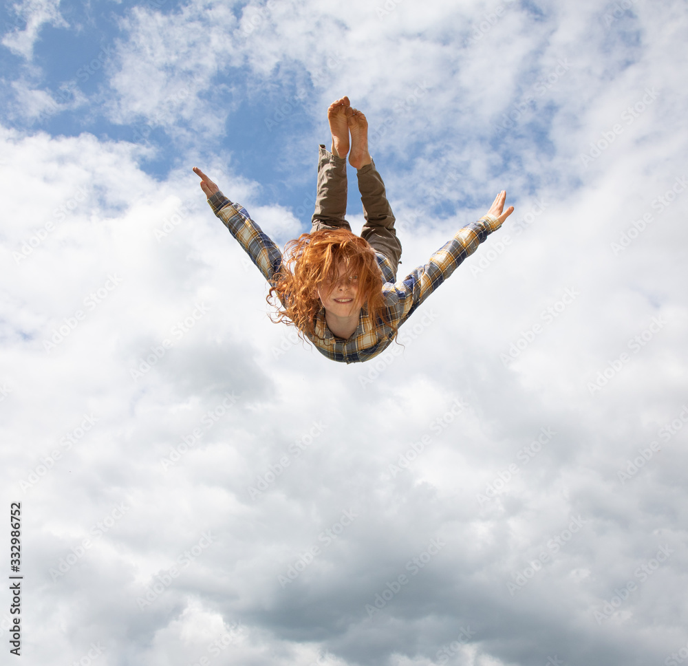 Young boy flying in the air Stock Photo | Adobe Stock