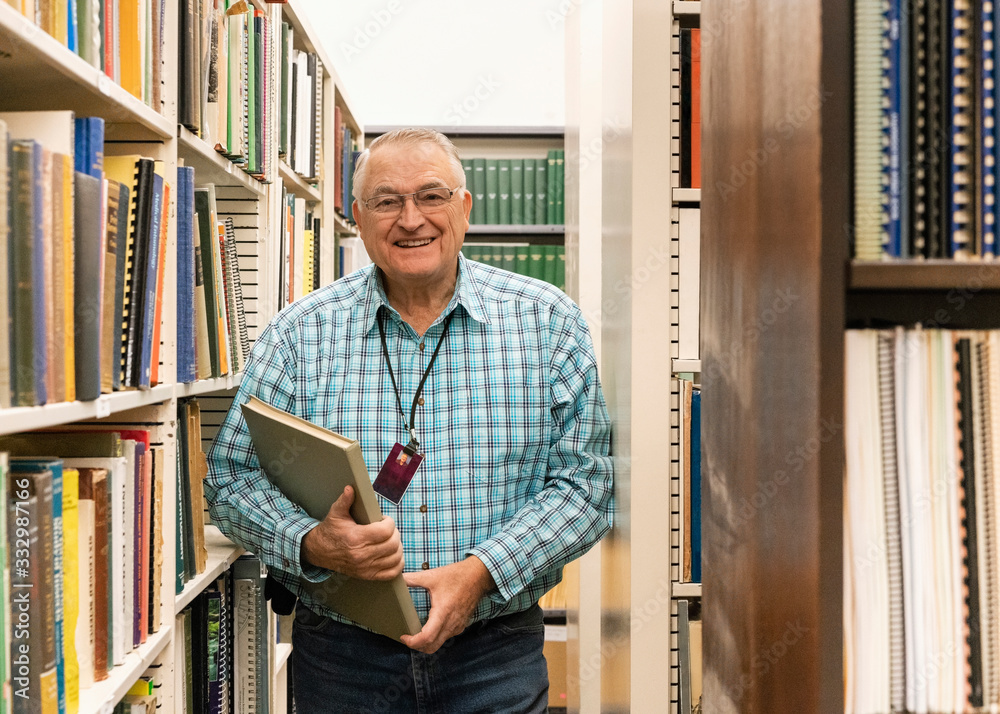 Librarian in the stacks at college museum library Stock Photo | Adobe Stock