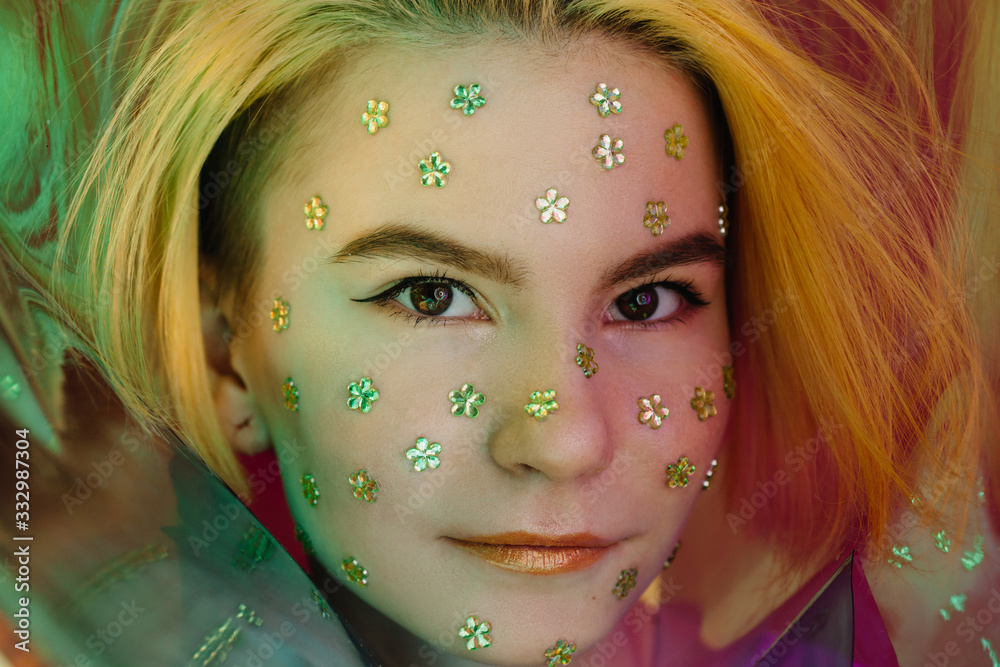 Crop face portrait of girl with yellow flowers on her skin in ...