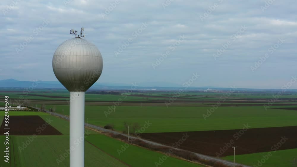 Old style, old looking ball-shaped water tower standing out of the ...