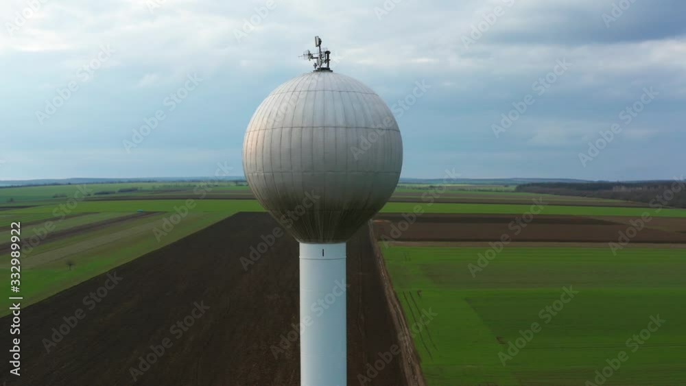 Old style, old looking ball-shaped water tower standing out of the ...