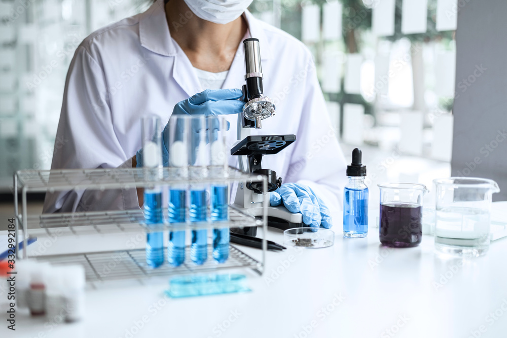 Biochemistry laboratory research, Chemist is analyzing sample in ...