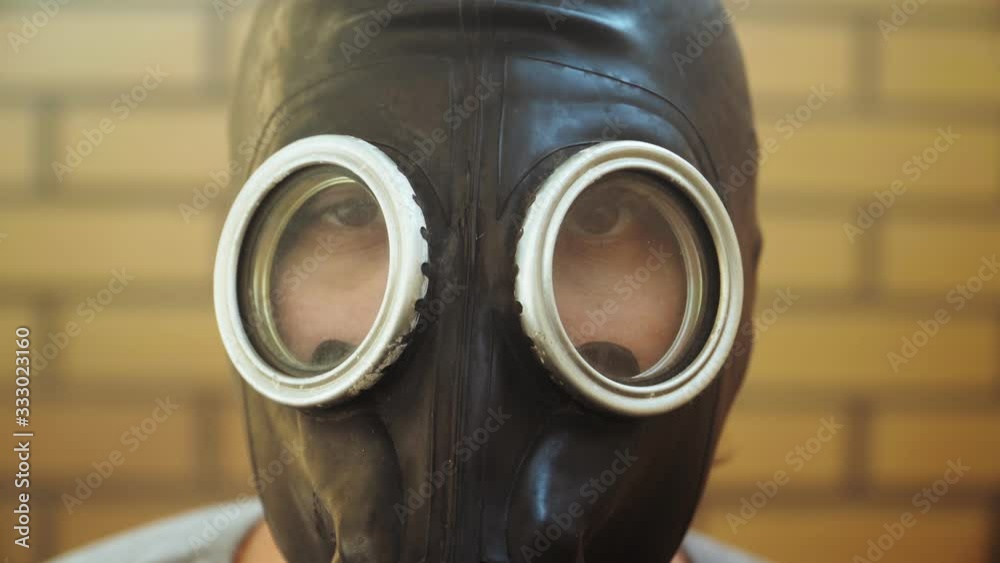 The guy in the gas mask looking directly at the camera. Against a brick ...