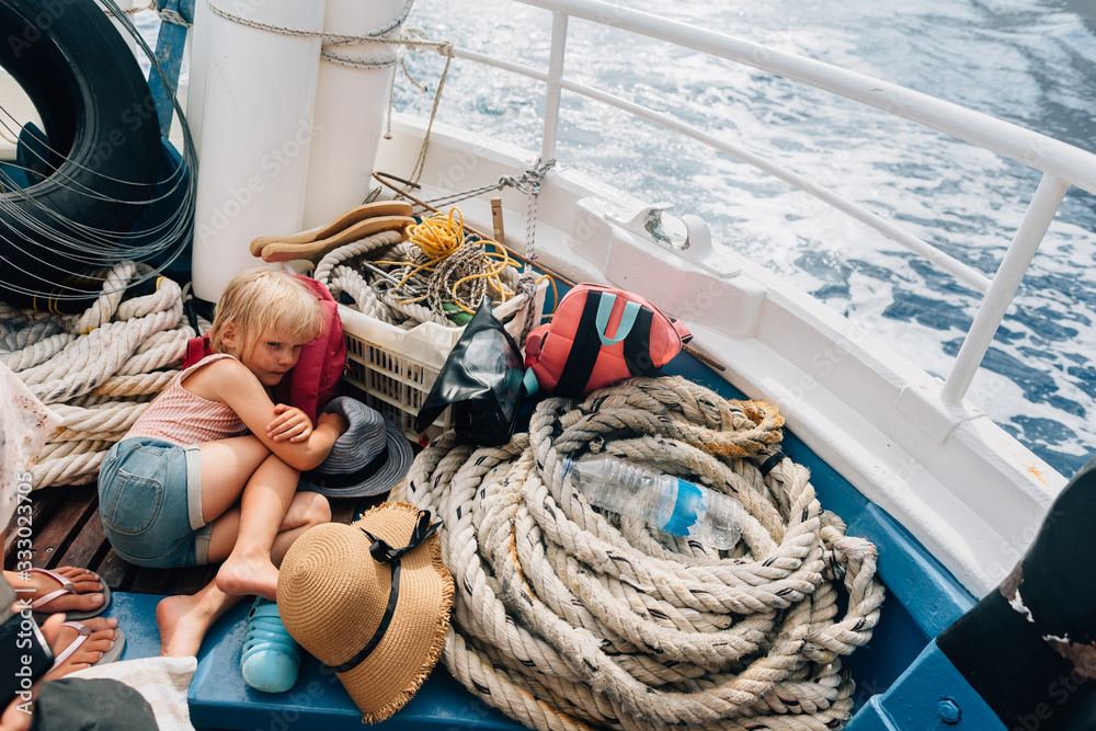 Little girl laying on the boat de?k floating in the sea Stock Photo ...