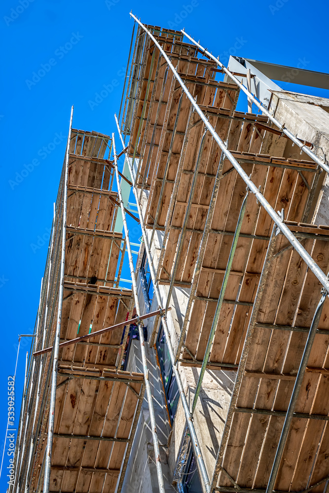 Construction site with scaffold building, scaffolding on a new building ...