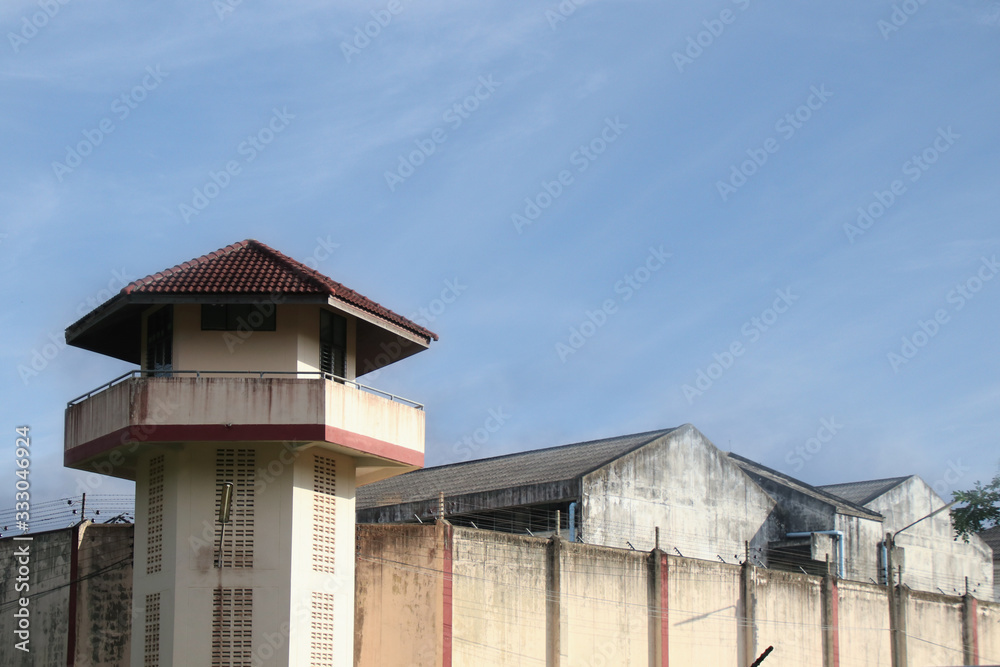 Prison watchtower protected by wire of prison fence.White prison wall ...