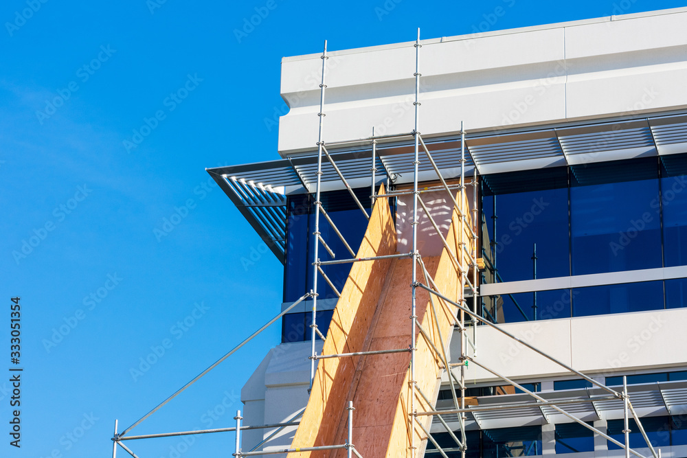 Construction debris chute made from wood installed on scaffolding at ...