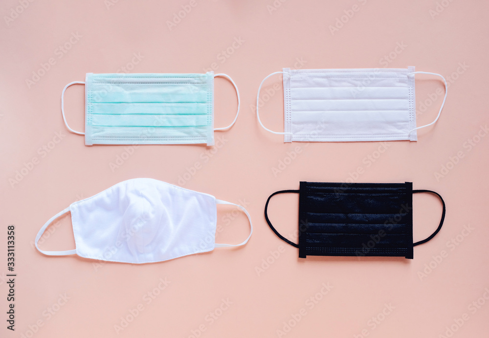 Flat lay of various kind and color of hygienic masks on bright pastel ...