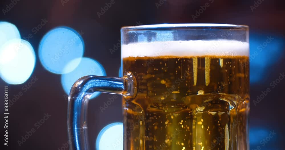 Extreme close up of one half liter glass mug full of beer with bubbles ...