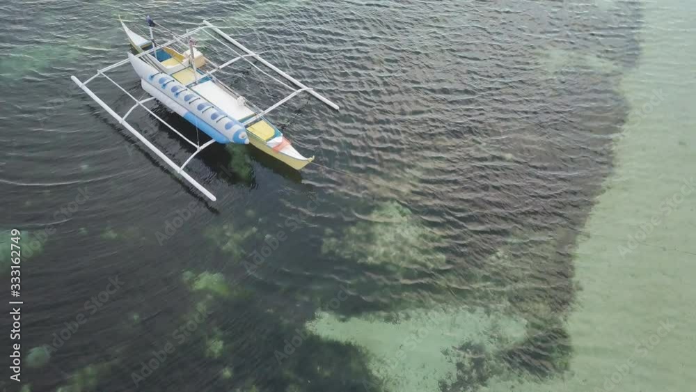 4K Top down aerial shot: flying low above a small bangka (typical ...