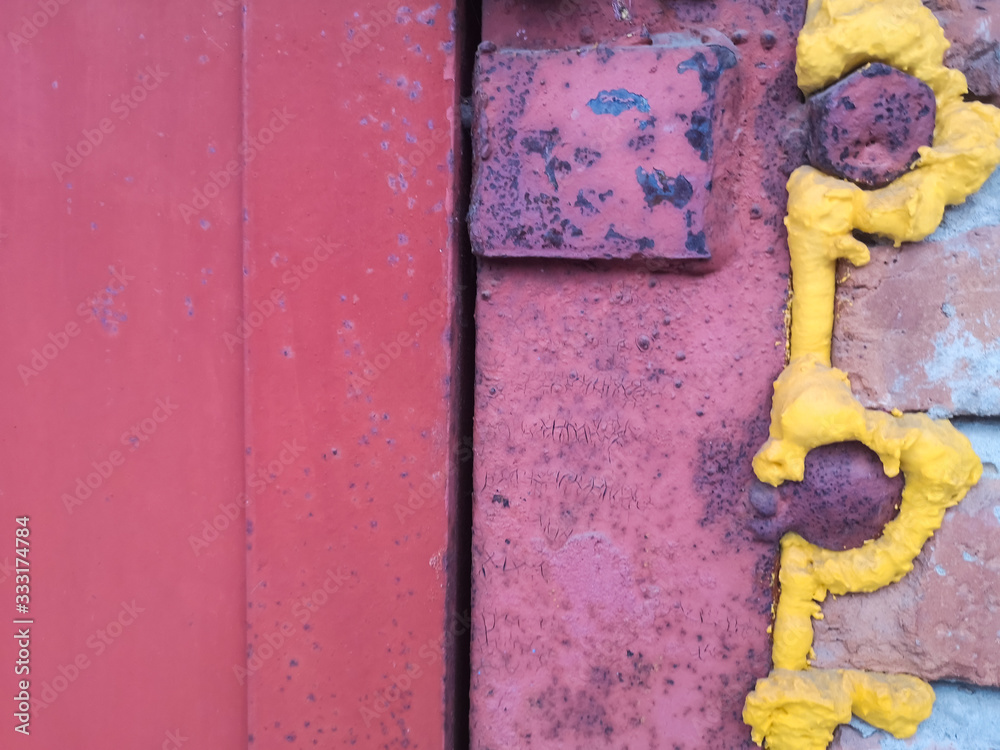 Texture of a red brick wall between painted iron forts. background ...