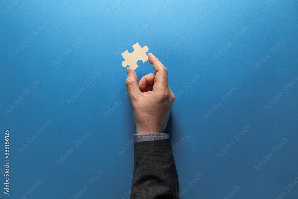 Hand of businessman in suit holds puzzle. Problem in business and ...