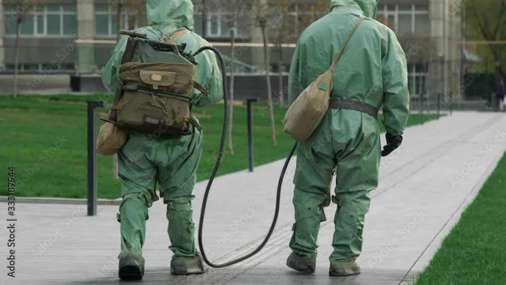 People in bio viral hazard protective suits. Disinfection and ...