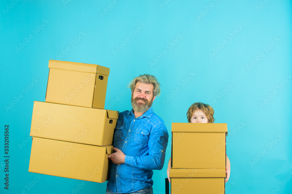 Father and son with boxes. Father with son carrying boxes on moving day ...