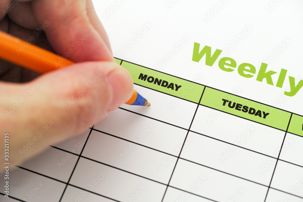 Poster Person writing weekly schedule with ballpoint pen – Wall Art ...