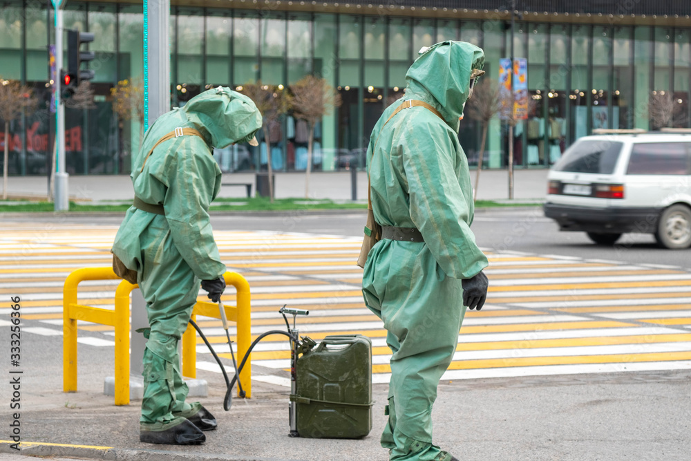 People in bio viral hazard protective suits. Disinfection and ...
