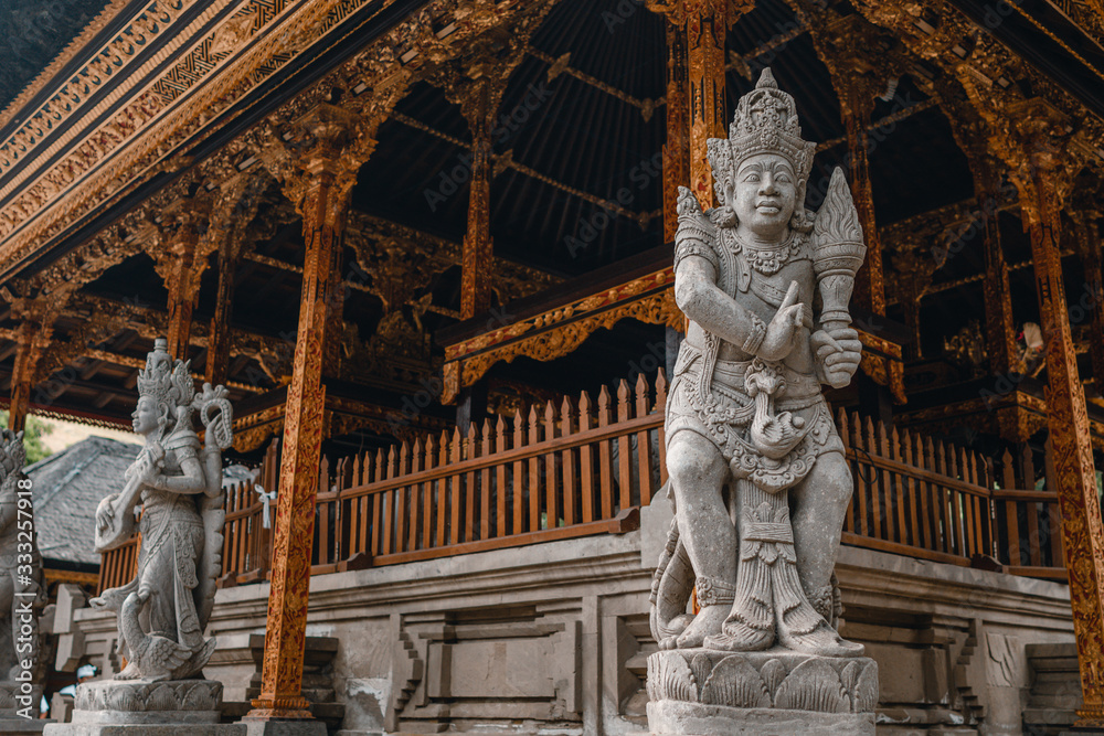 A close up on a guardian figure next to Pura Tirta Empul temple on Bali ...