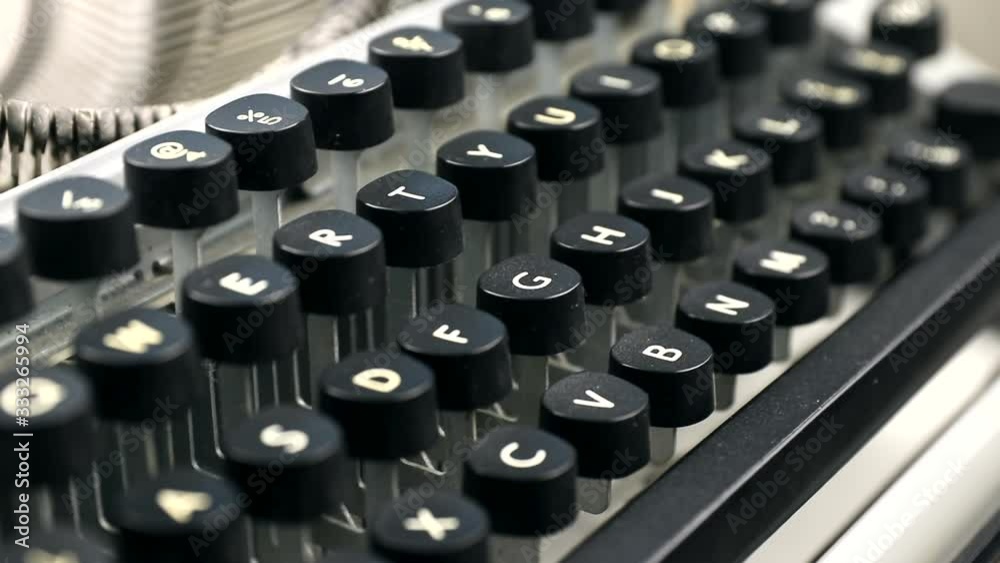 Close-up footage of keyboard and keys with letters of an old and ...