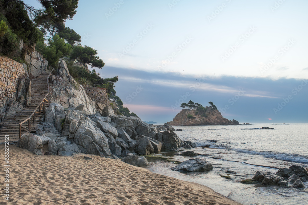 photo of dawn on the beach in Spain, rocky stairs on the beach in Spain ...