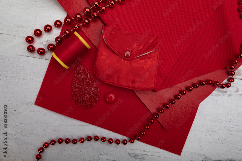 Red background different textures one color beads fabric tread design ...