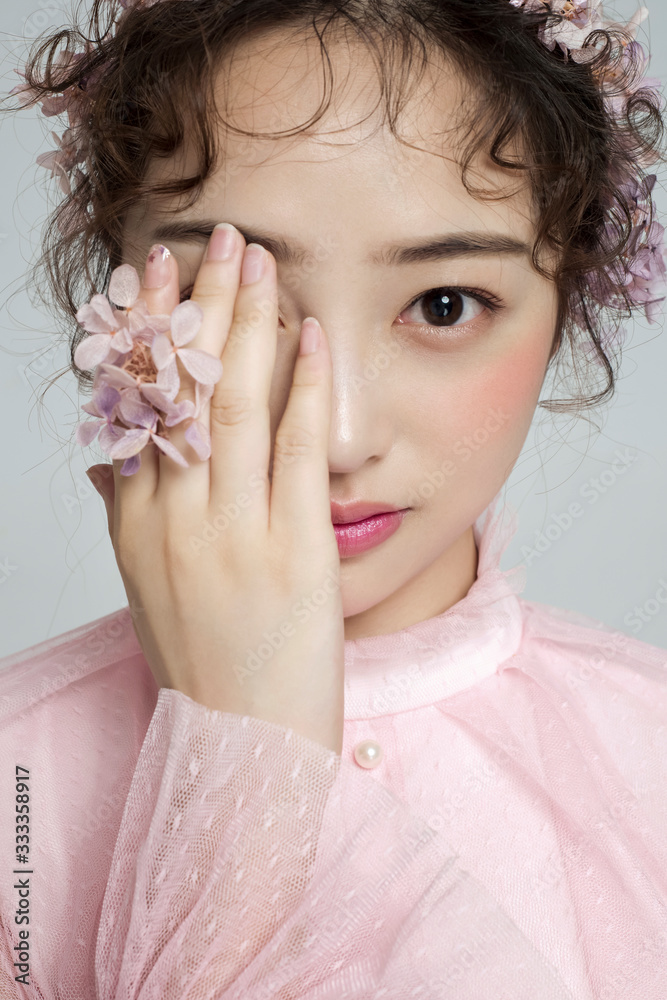 Asian teenage girl covering one eye with one hand Stock Photo | Adobe Stock