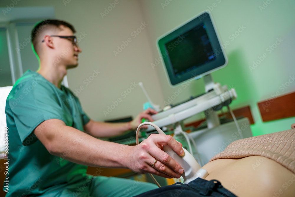 Doctor conducting ultrasound examination of woman in clinic. Ultrasound ...