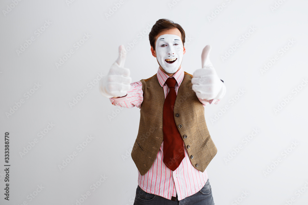 Portrait of man, actor, pantomime, man making class gesture, thumb up ...